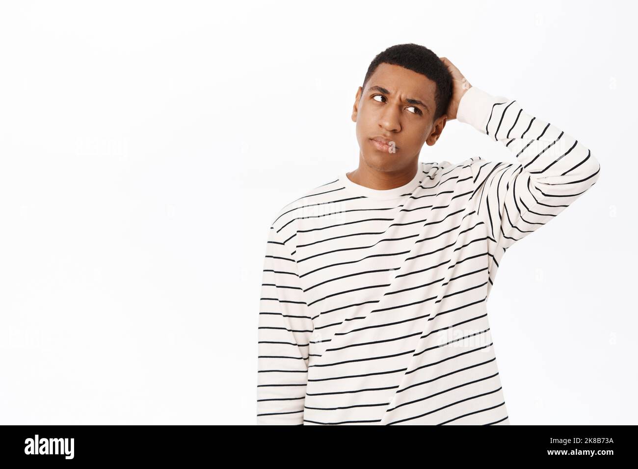 Puzzled african american man scratching head, looking confused, dont ...