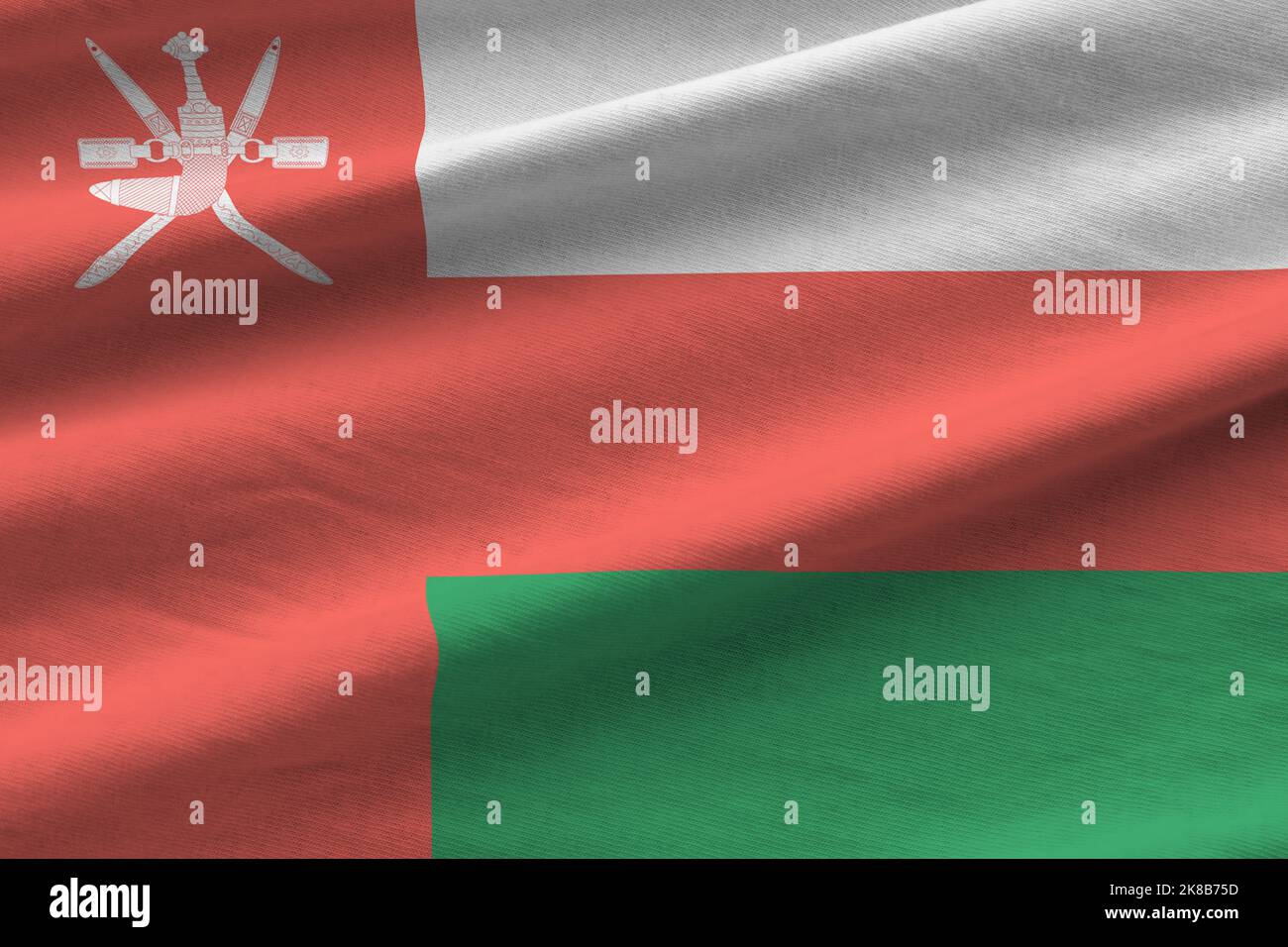 Oman flag with big folds waving close up under the studio light indoors ...