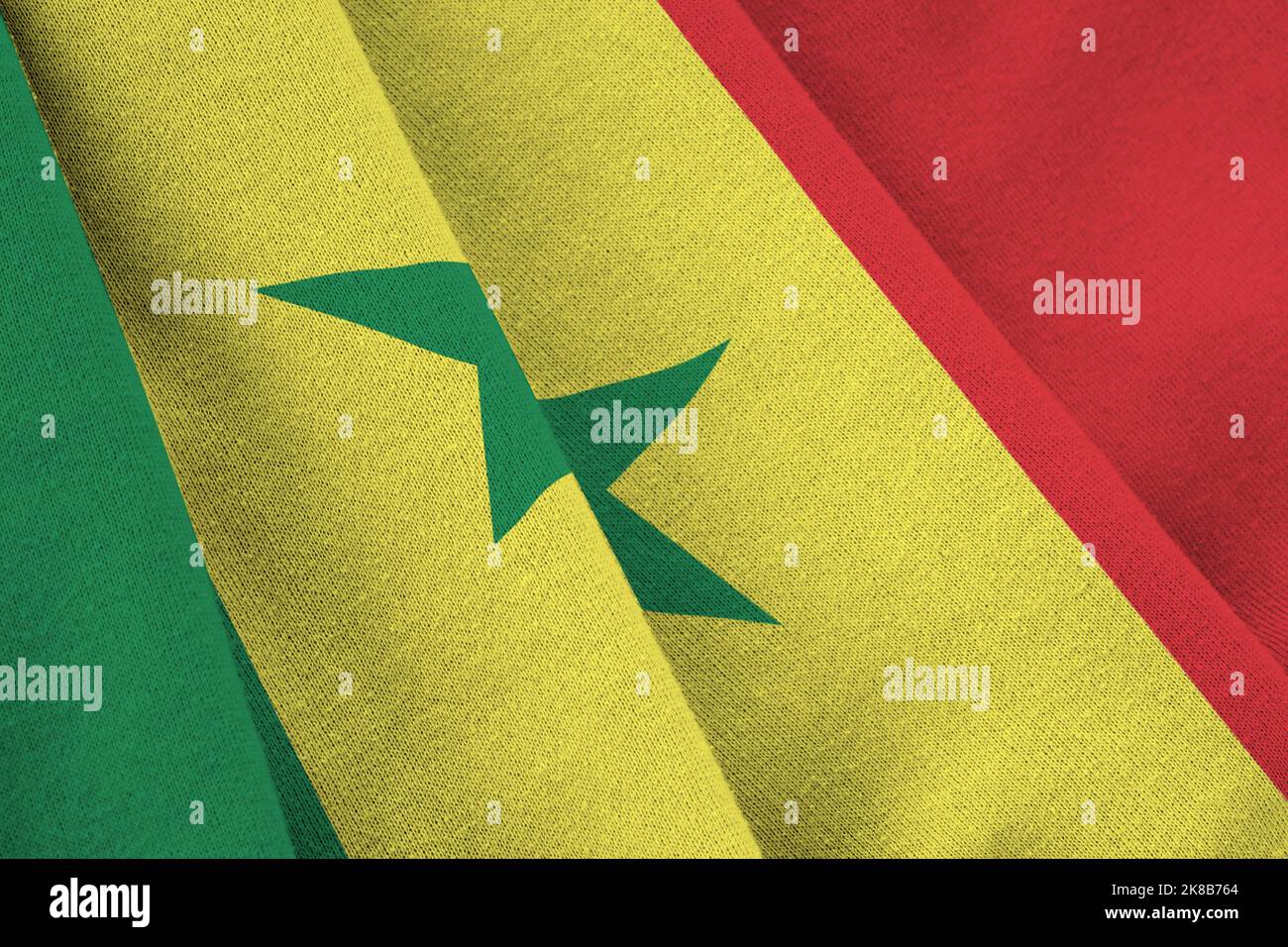 Senegal flag with big folds waving close up under the studio light ...