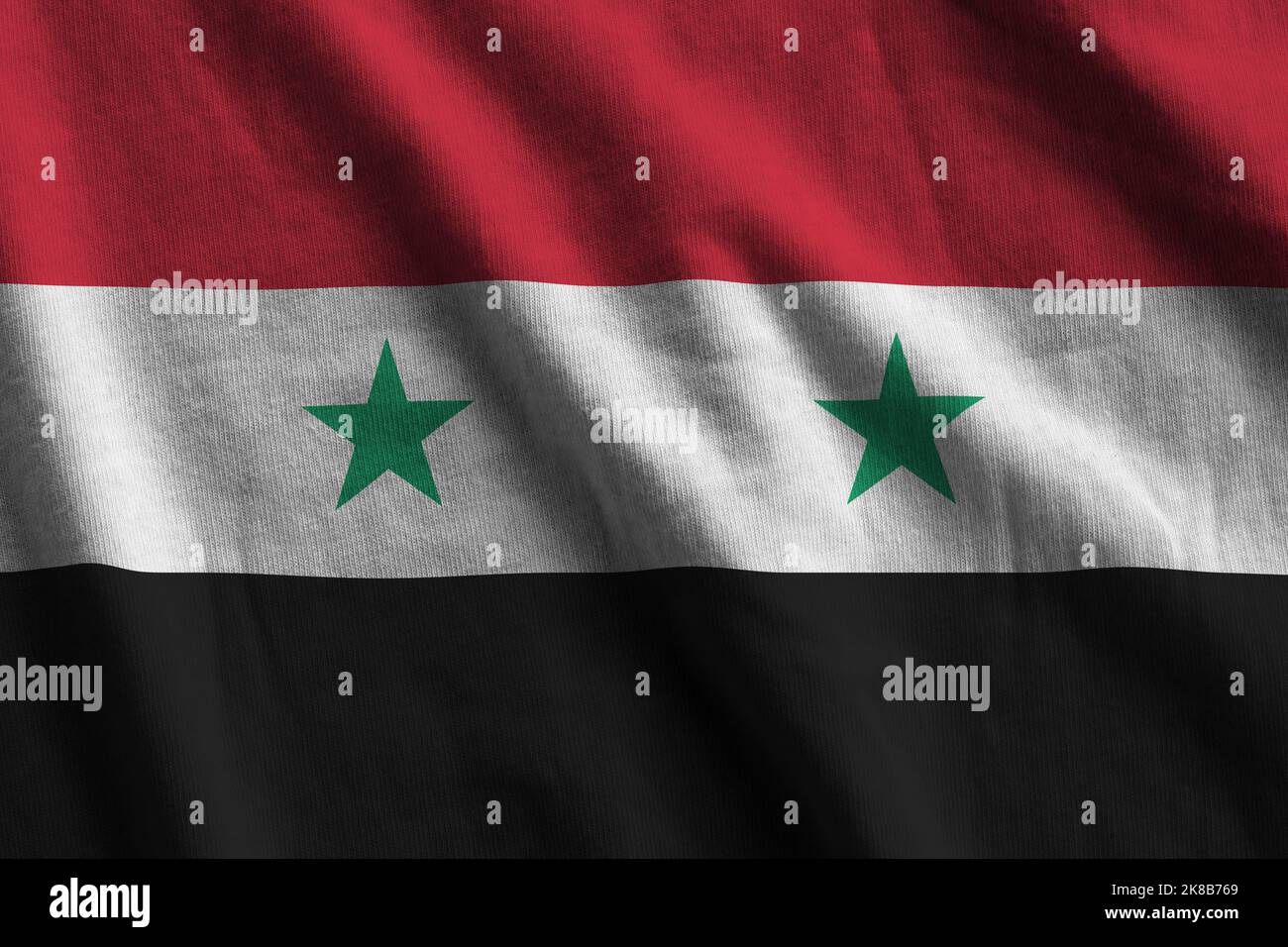 Syria flag with big folds waving close up under the studio light ...