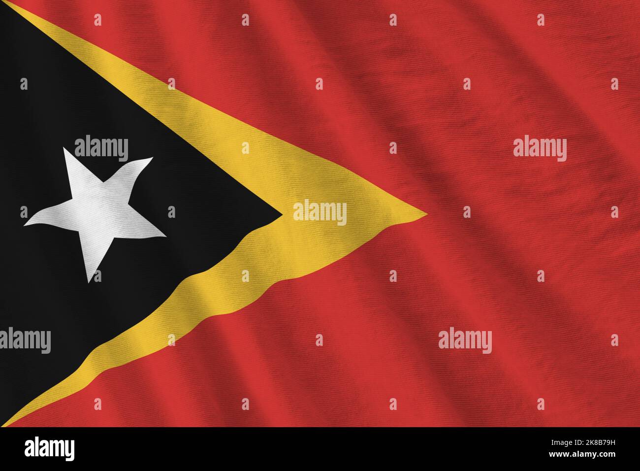 Timor Leste flag with big folds waving close up under the studio light ...