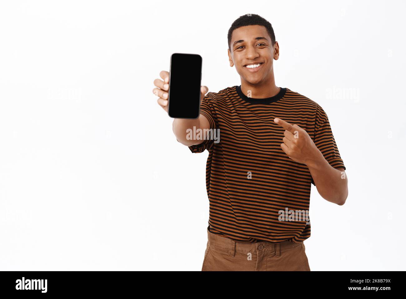 Happy smiling man shows mobile phone screen, produly demonstrating ...