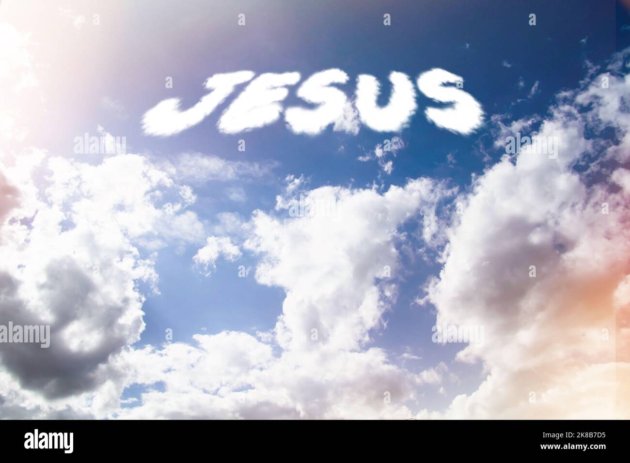 Jesus. Text from clouds in sky in bright sunlight Stock Photo - Alamy