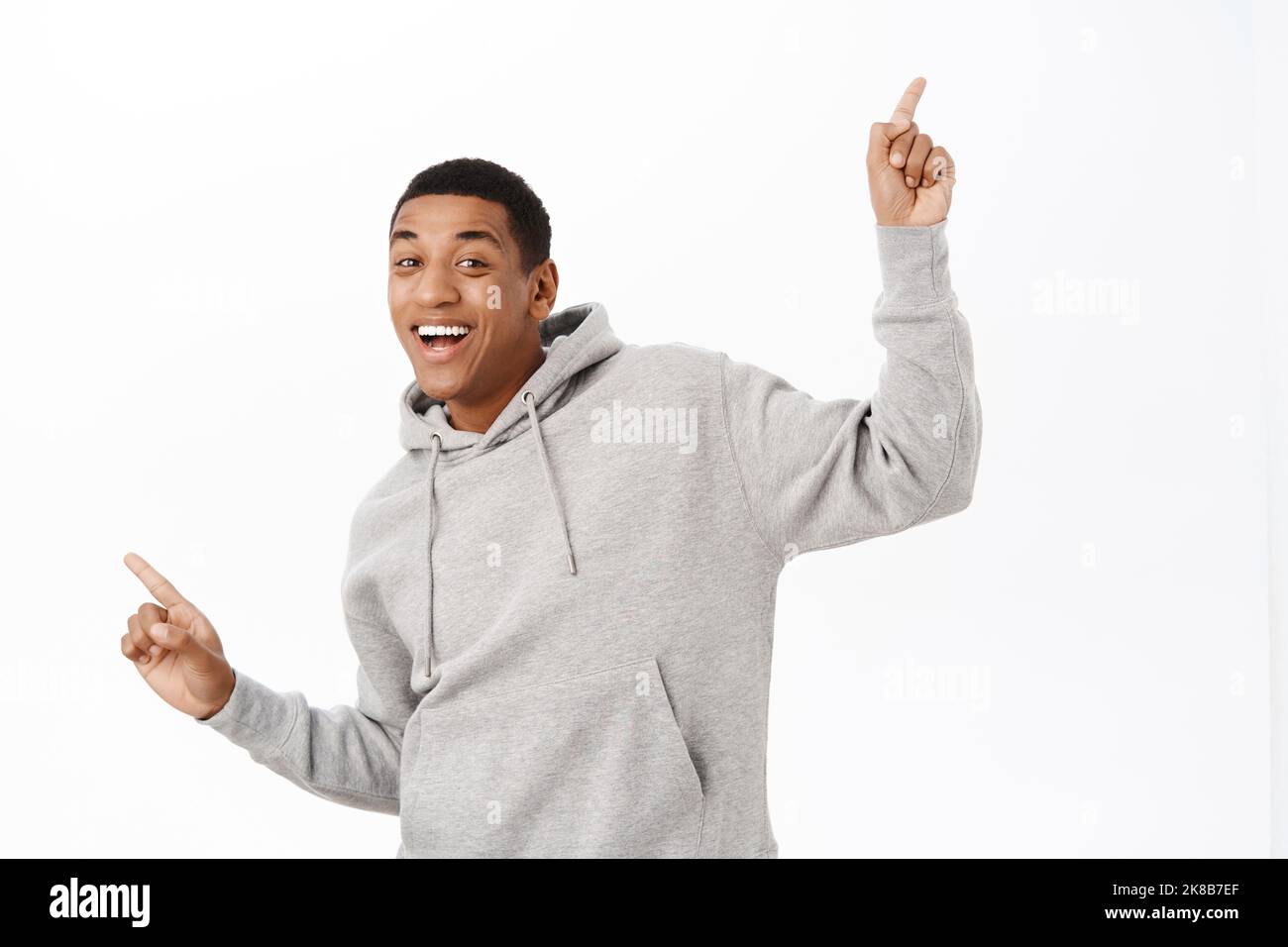 Happy smiling african american man pointing fingers sideways, showing ...