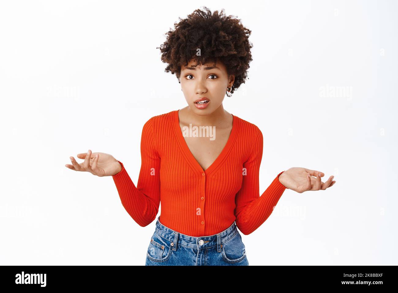 Image of confused african american woman shrugs shoulders, looks ...
