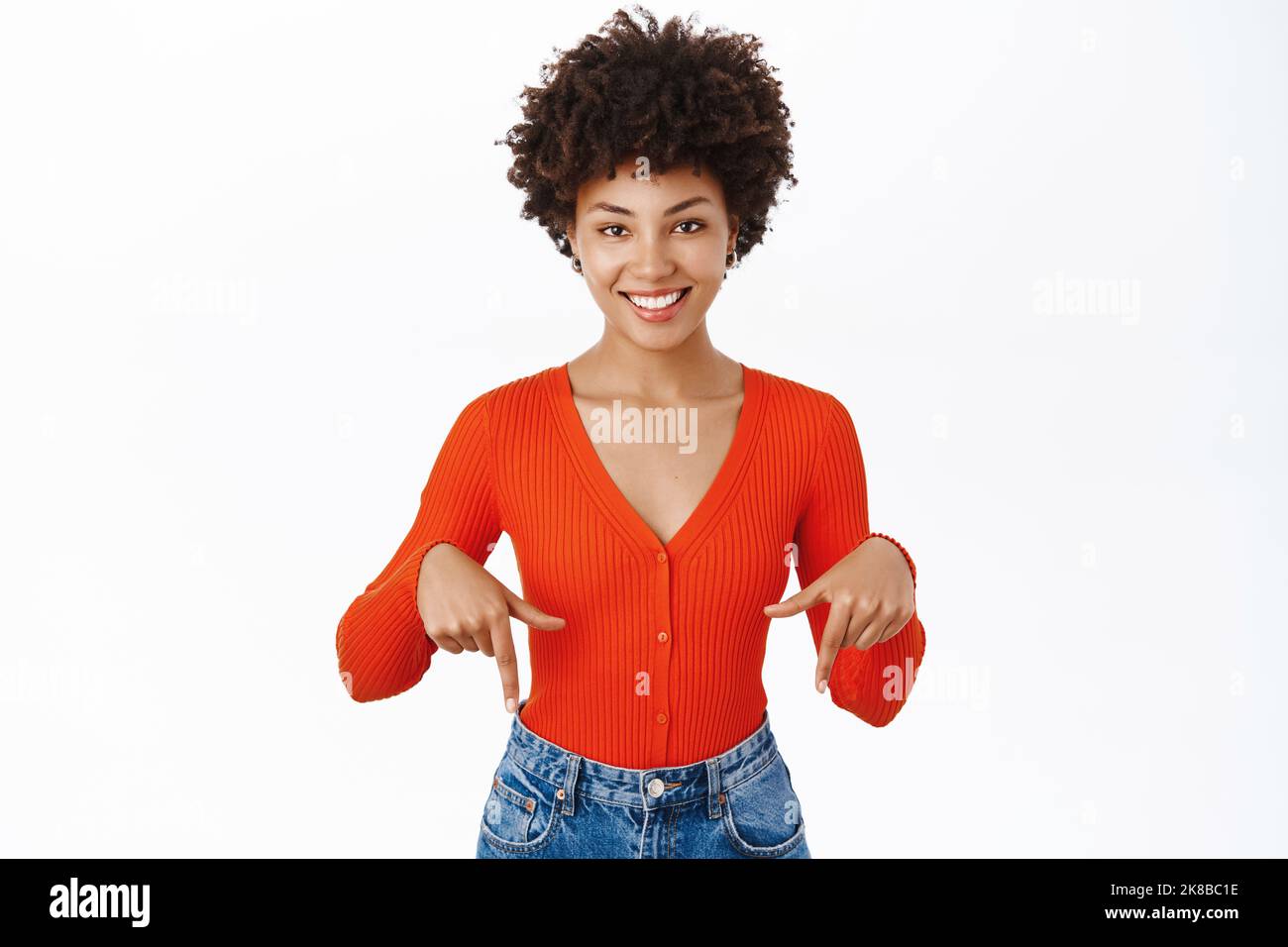 Stylish african american female model pointing fingers down, showing ...