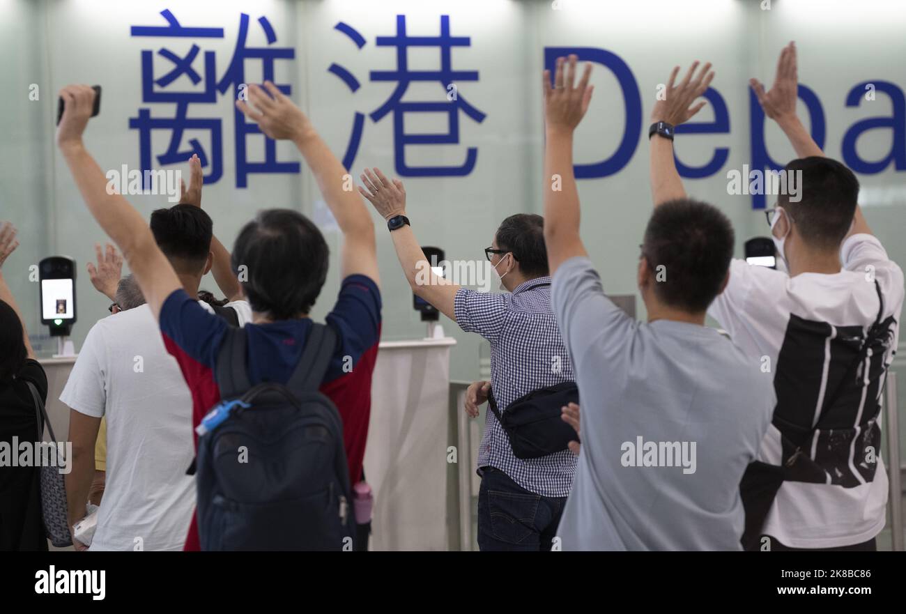 Friends and family wave goodbye to travelers at departures area on Hong ...
