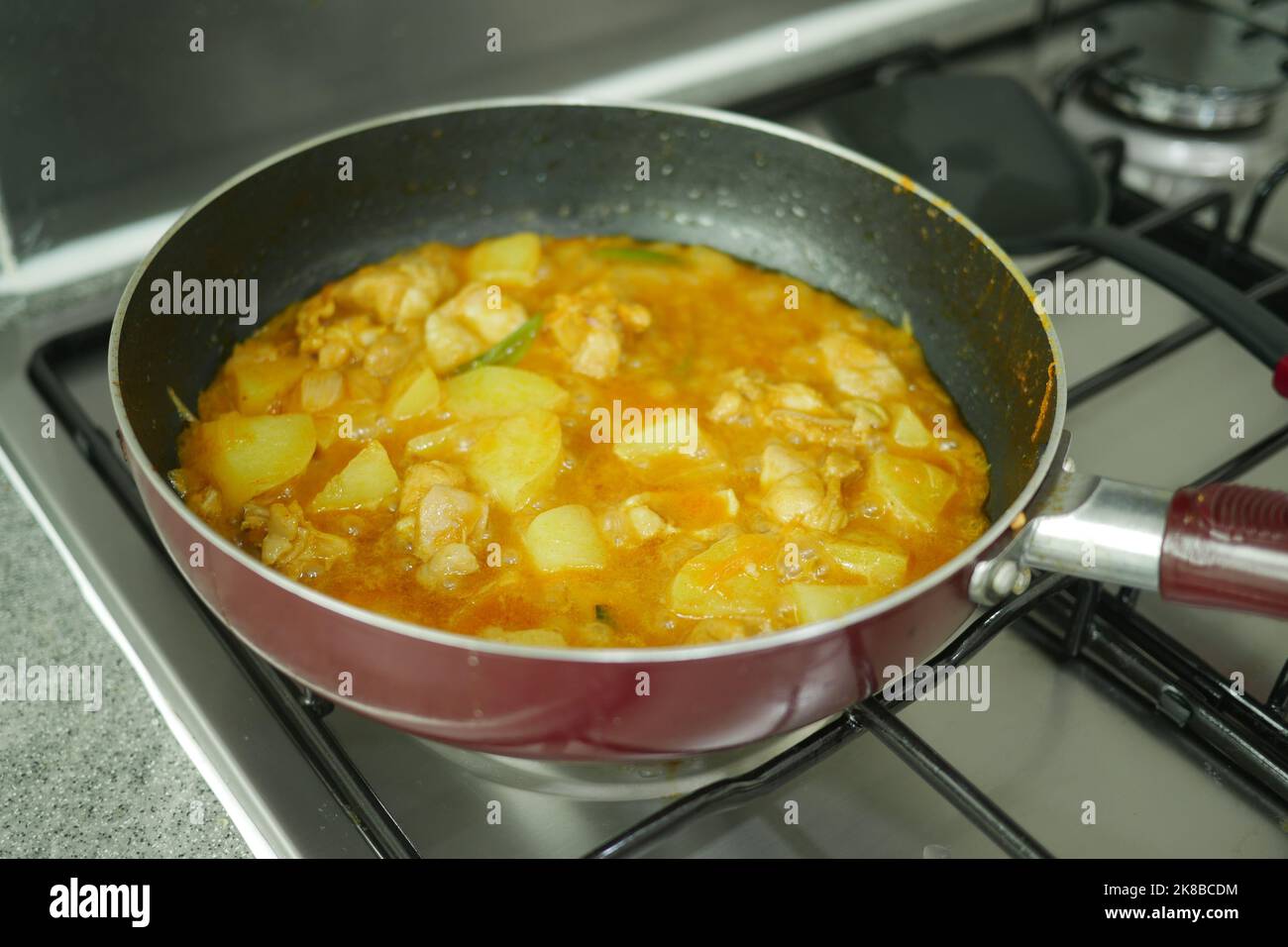cooking chicken curry in a cooking pan Stock Photo - Alamy