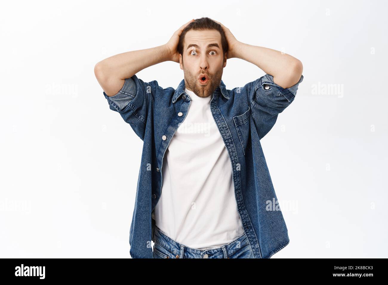 Image of guy looks happy and surprised, receive great news, smiles with ...