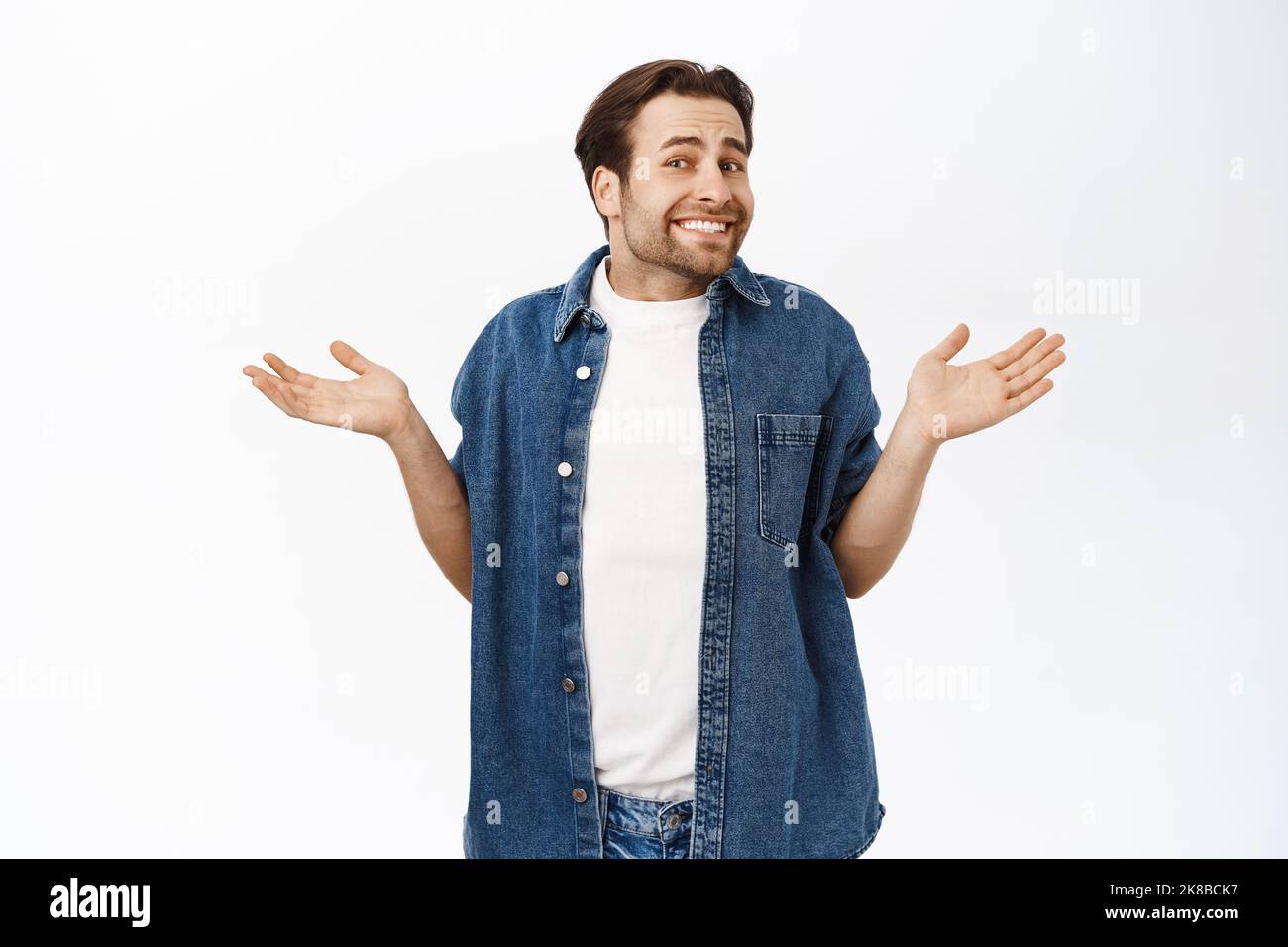 Oops sorry. Man smiles silly and shrugs shoulder, looks unaware, dont ...