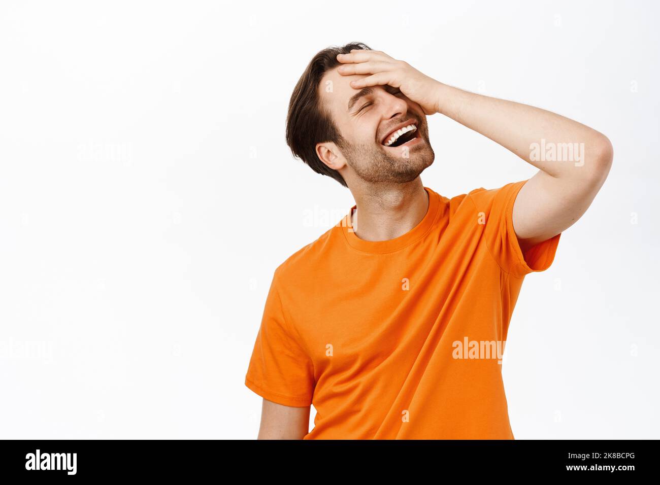 Enthusiastic adult man, laughing and smiling, showing genuine happiness ...