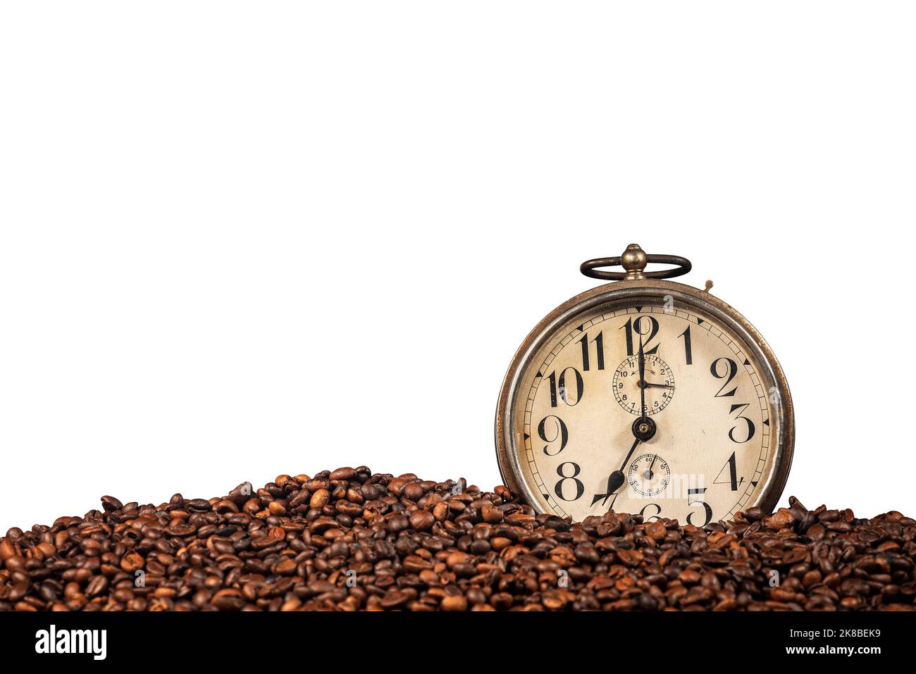 Closeup of an old alarm clock (seven o'clock) and a stack of roasted ...