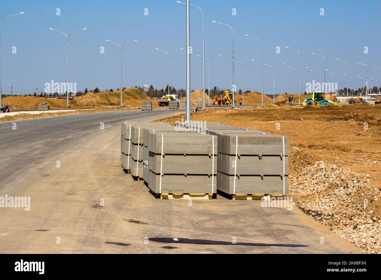 Laying a curb stone between the carriageway and the pedestrian zone ...