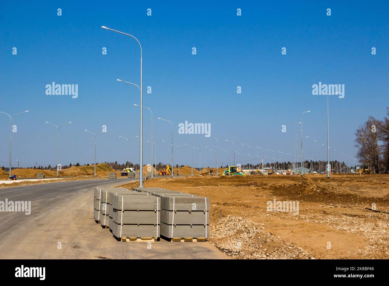 Laying a curb stone between the carriageway and the pedestrian zone ...