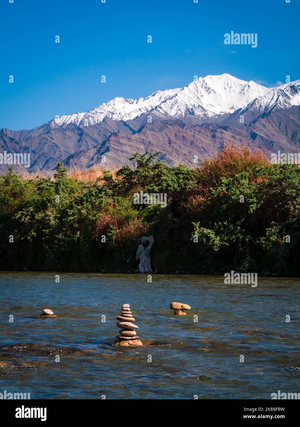 Pyramid stones balance on the river at Ladakh. The object is in focus ...