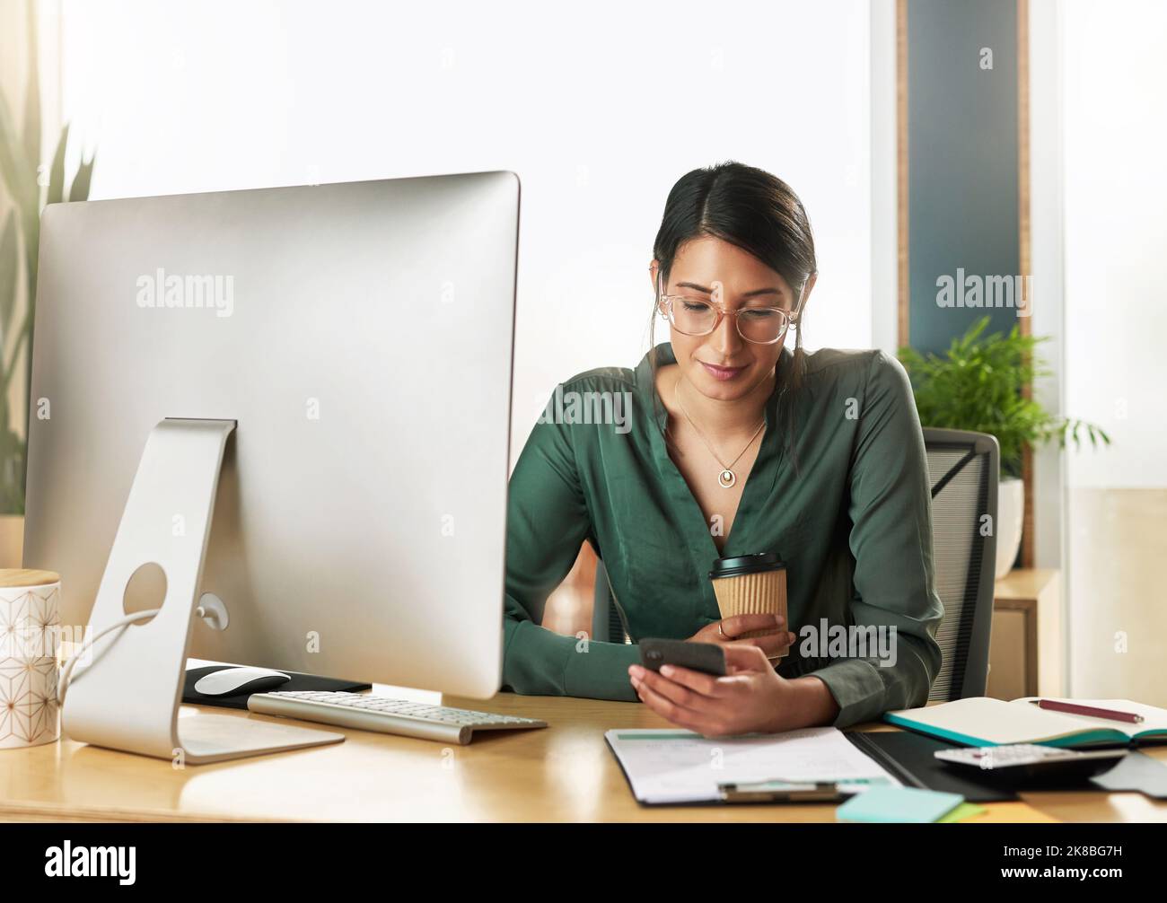 Coffee chats are the way I start my day. a young businesswoman using ...