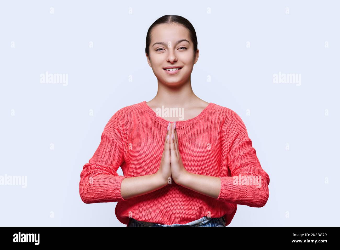 Woman pressing hands together hi-res stock photography and images - Alamy