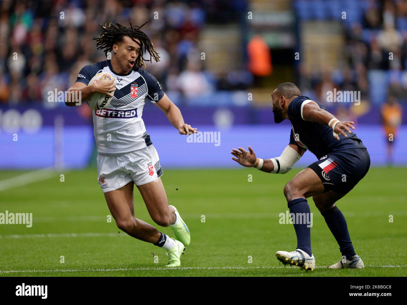 England's Dom Young (left) hands off France's Samisoni Langi during the ...