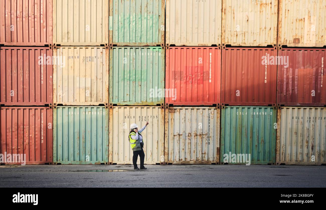 Logistics, shipping yard and cargo containers manager woman talking on ...