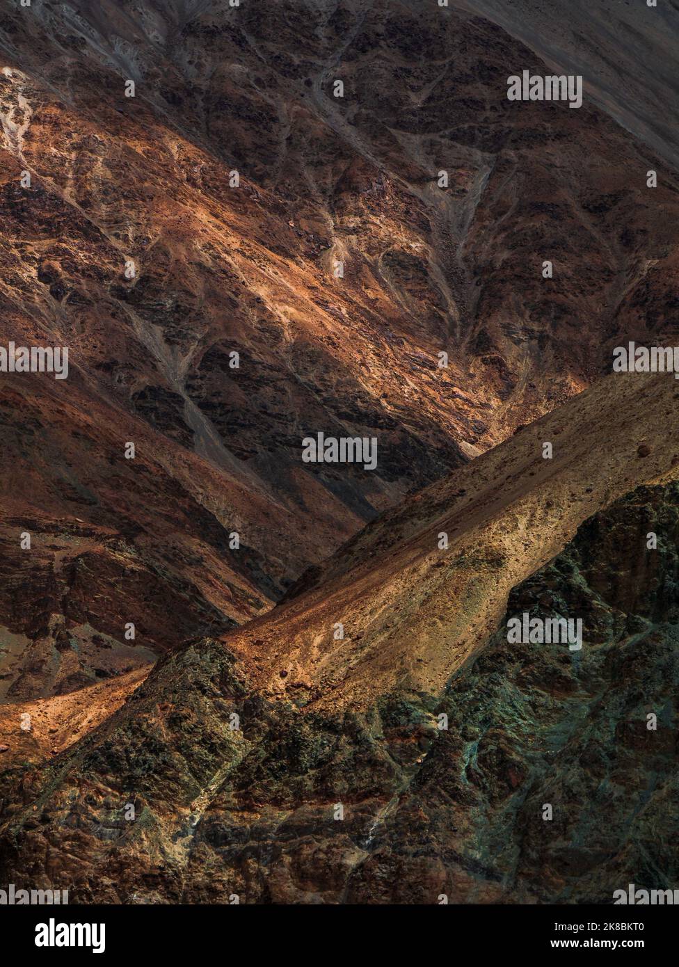 Stone texture on a mountain face with sun light. Shadows and Highlights ...