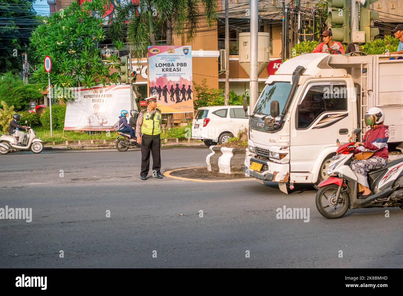 Traffic police on crossroad controls and regulates traffic on street ...