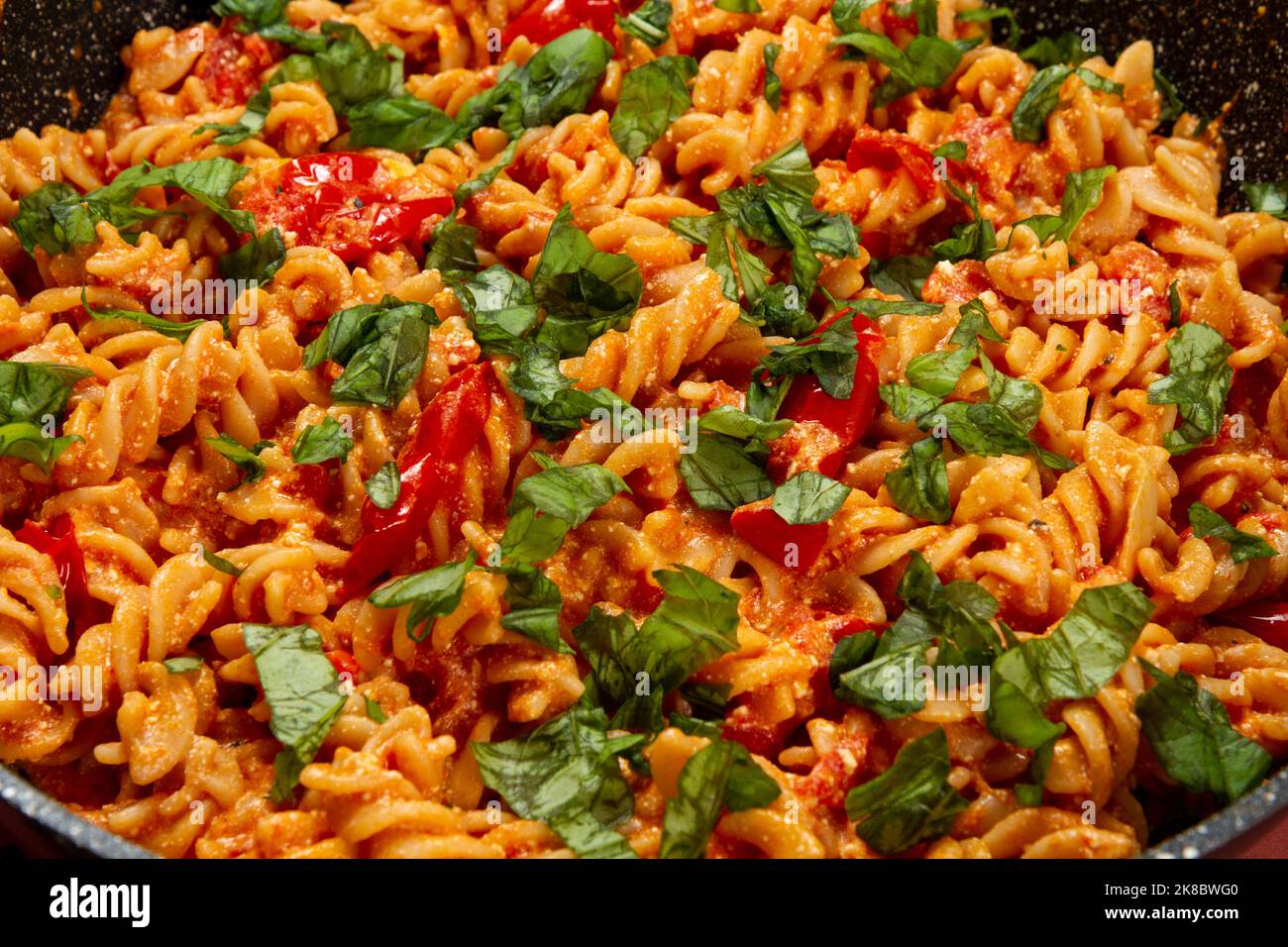 Feta tomato pasta bake (wholewheat fuseli Stock Photo - Alamy
