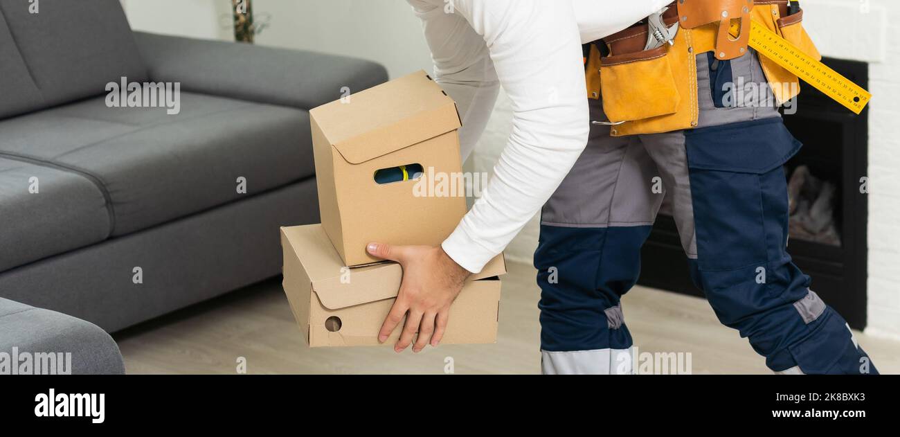 Young man working at a warehouse with boxes Stock Photo - Alamy