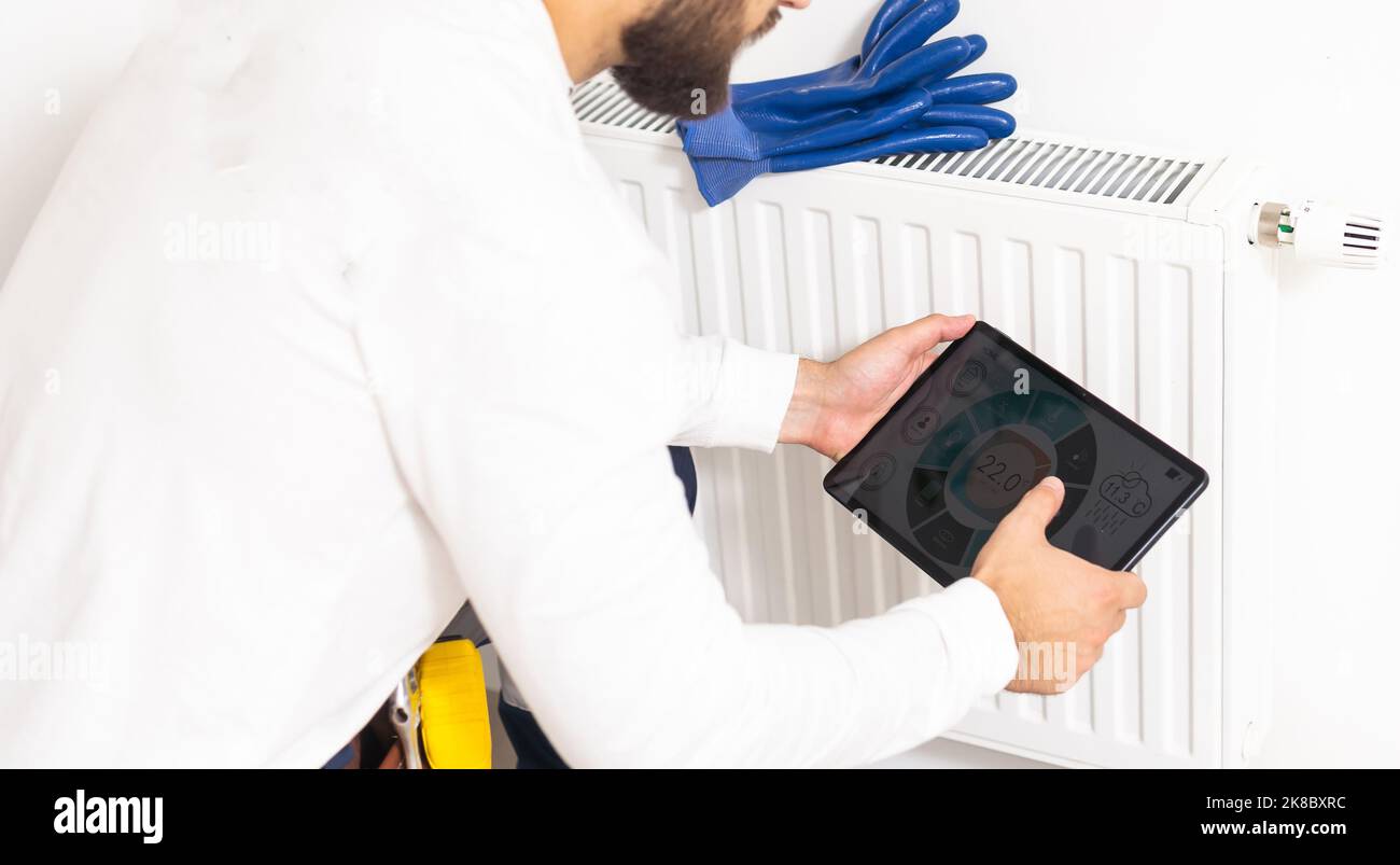Repair heating radiator close-up. man repairing radiator with wrench ...