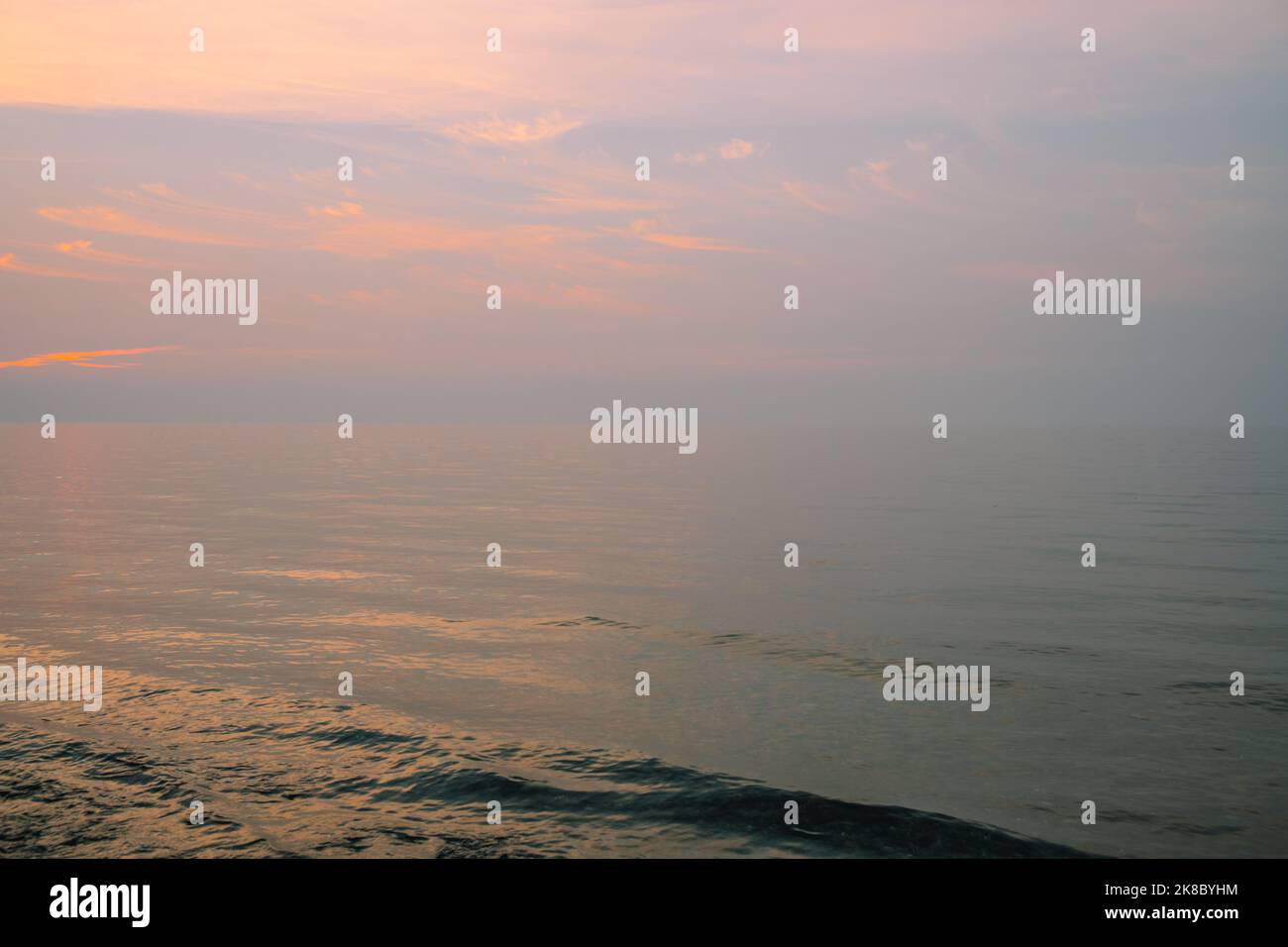 pink smoky sunset over water with clouds Stock Photo - Alamy