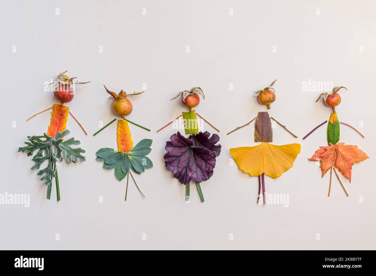 cute figures, dancers made from colorful leaves and bright flowers on ...