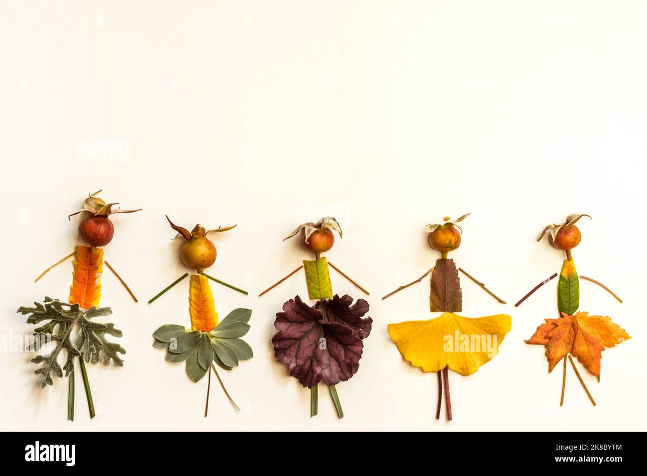 cute figures, dancers made from colorful leaves and bright flowers on ...