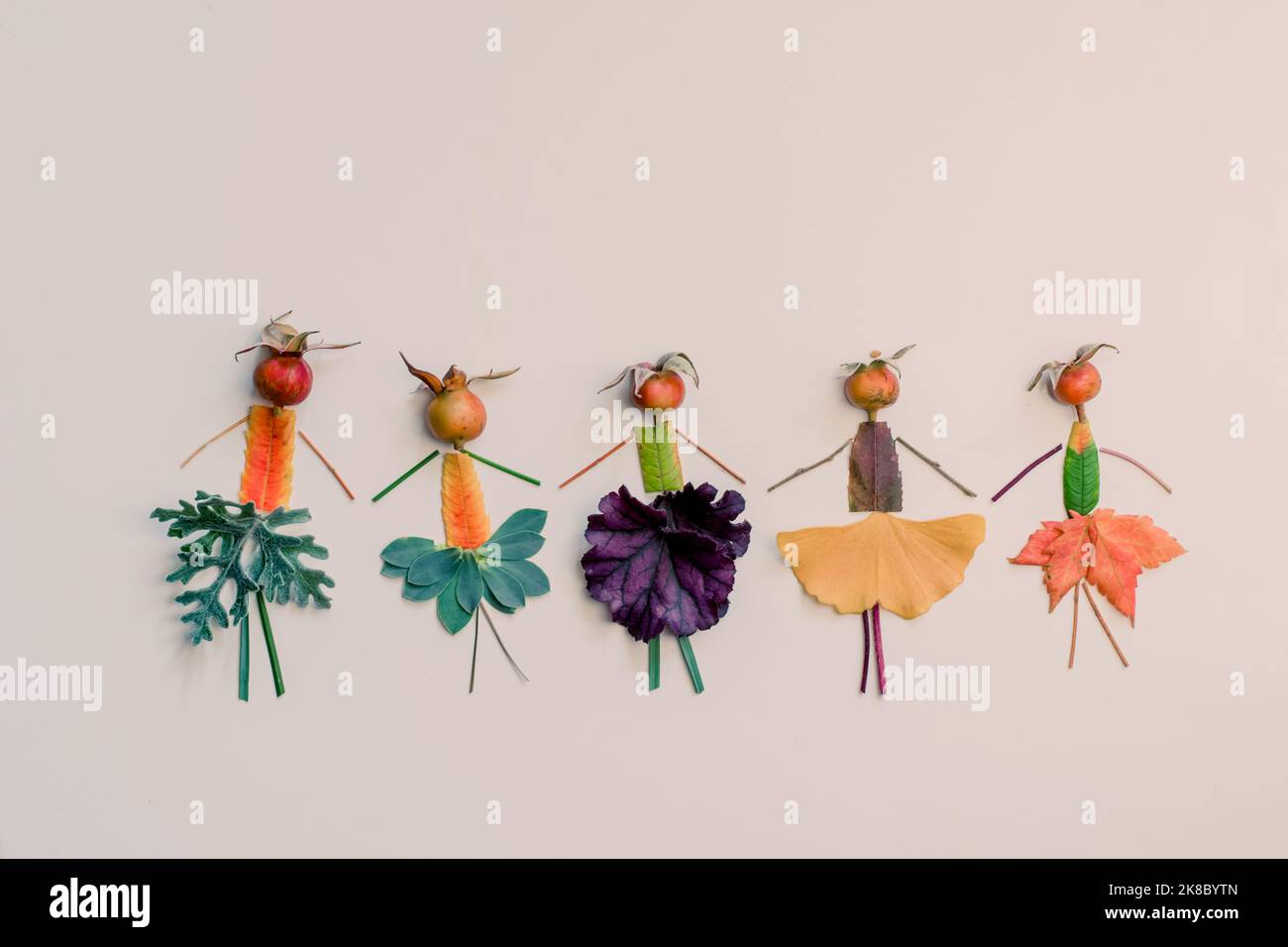 cute figures, dancers made from colorful leaves and bright flowers on ...