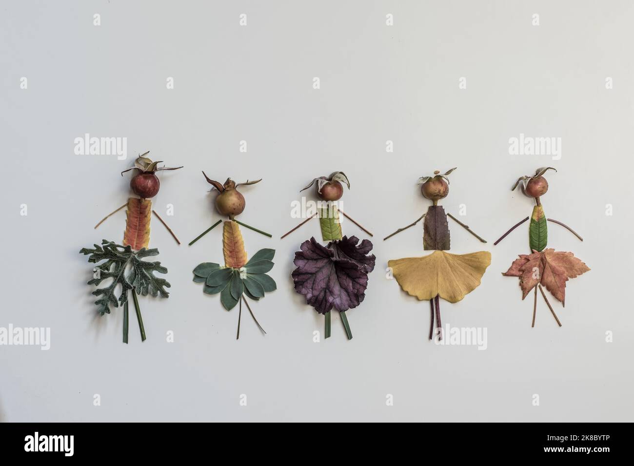 cute figures, dancers made from colorful leaves and bright flowers on ...