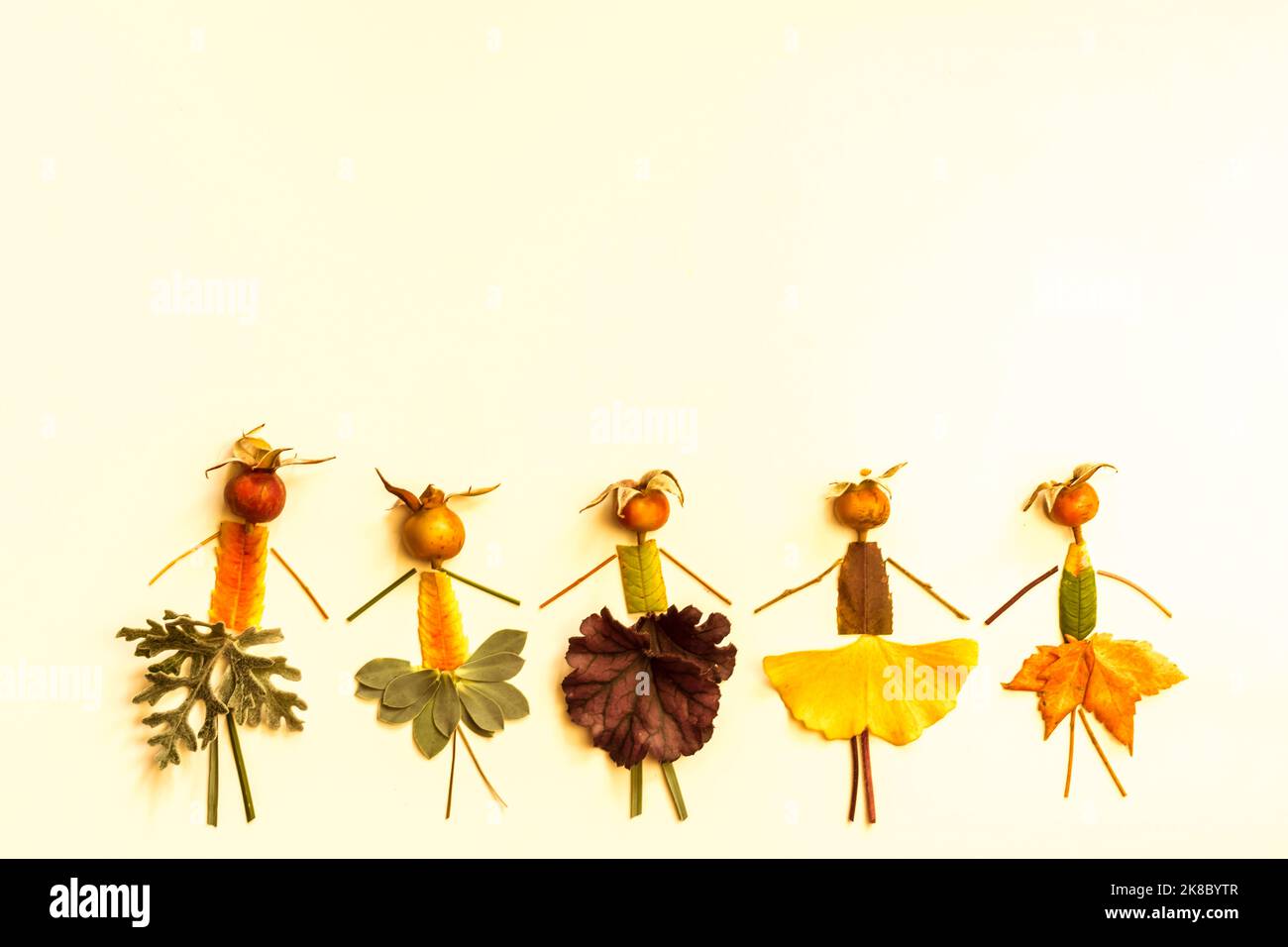 cute figures, dancers made from colorful leaves and bright flowers on ...