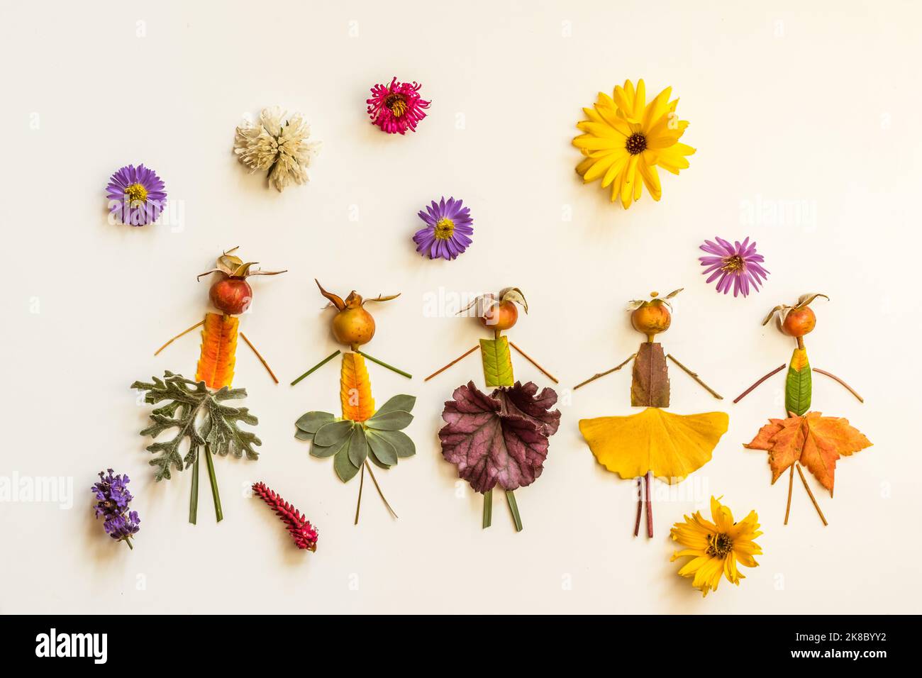 cute figures, dancers made from colorful leaves and bright flowers on ...