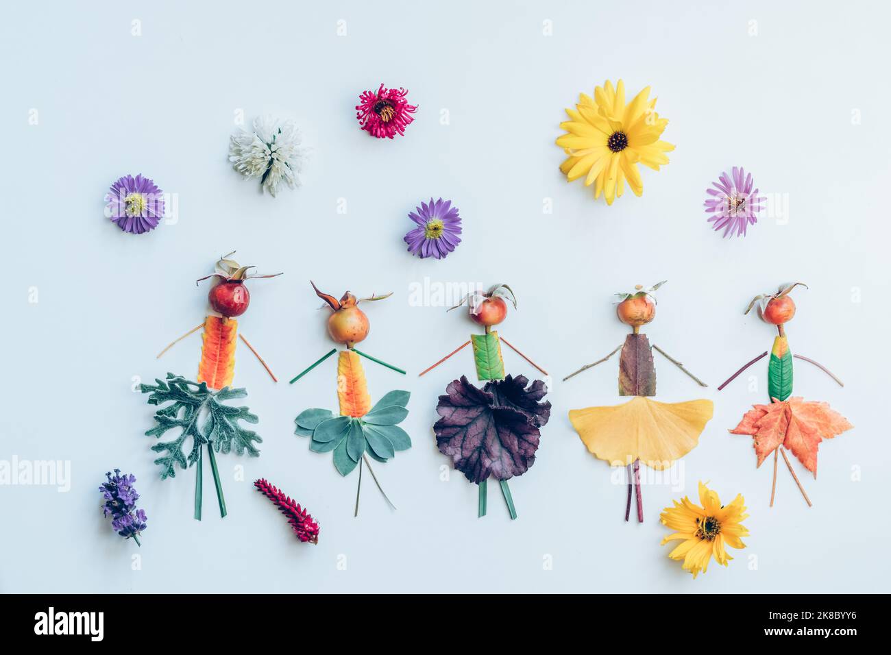 cute figures, dancers made from colorful leaves and bright flowers on ...
