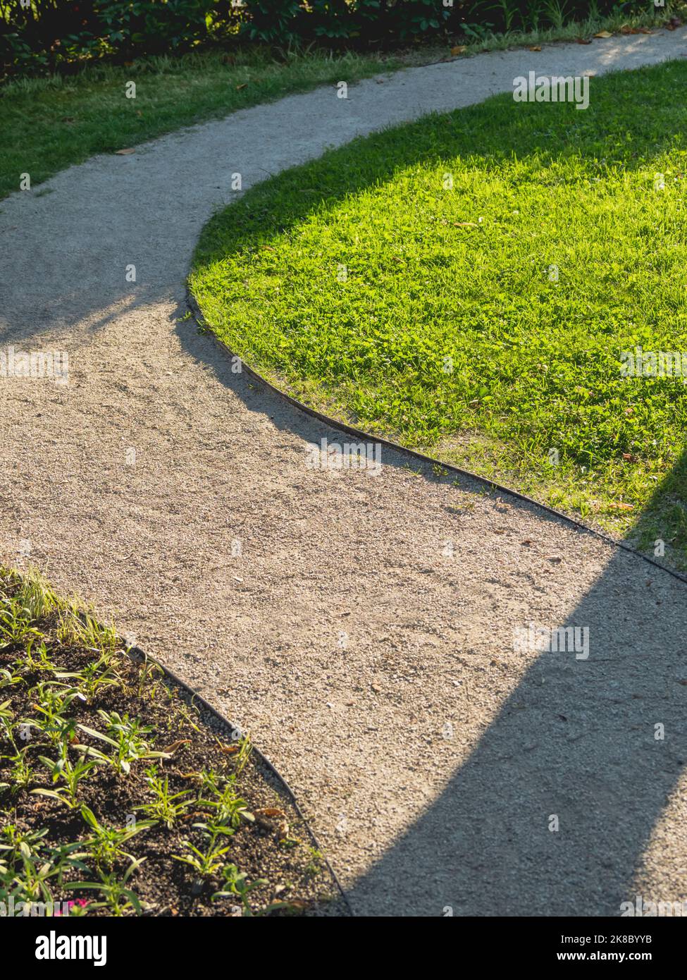 Walking path winding among lawns in garden. Landscaping in park Stock ...