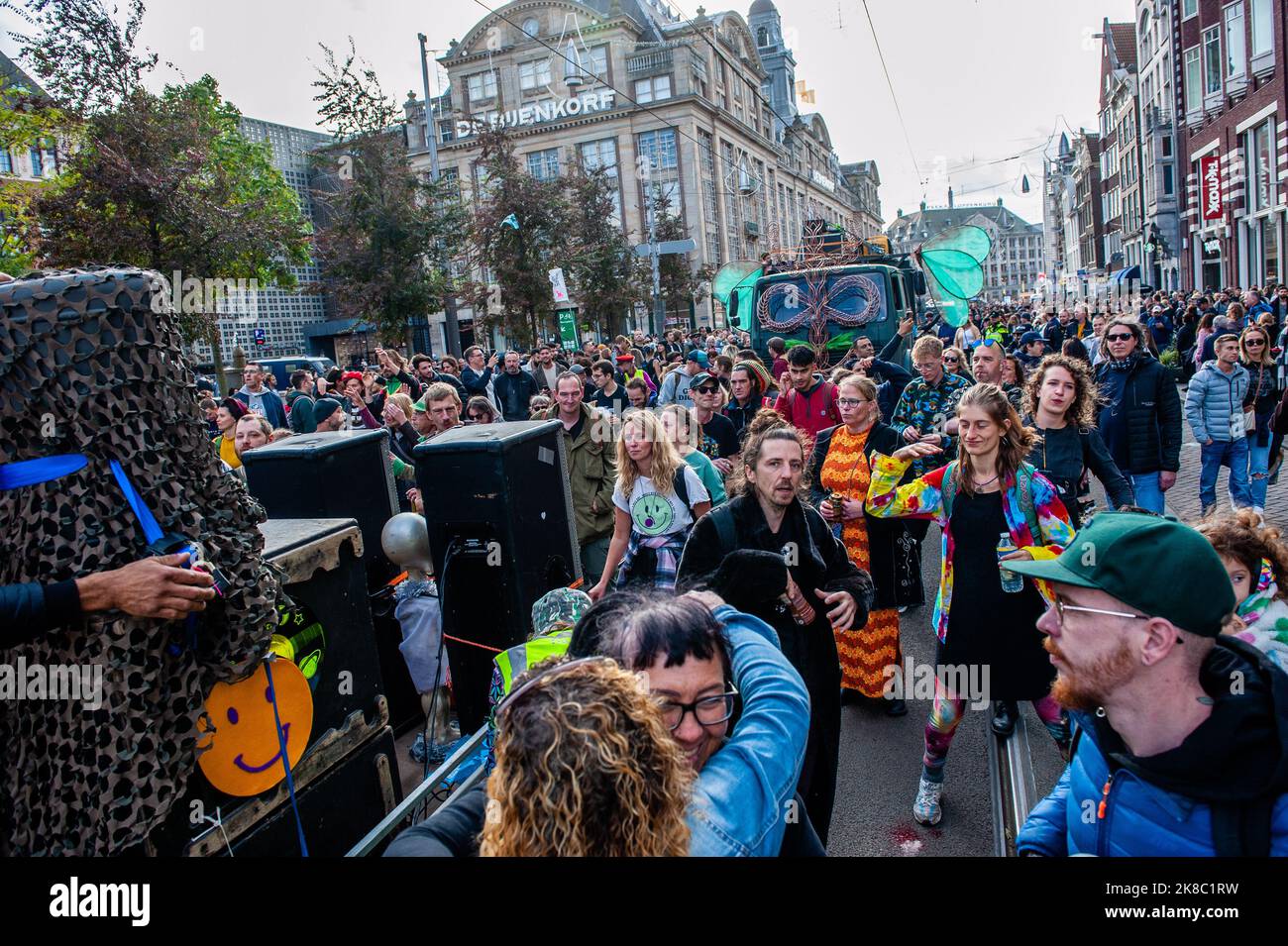 Thousands of people are seen dancing behind one of the trucks with ...