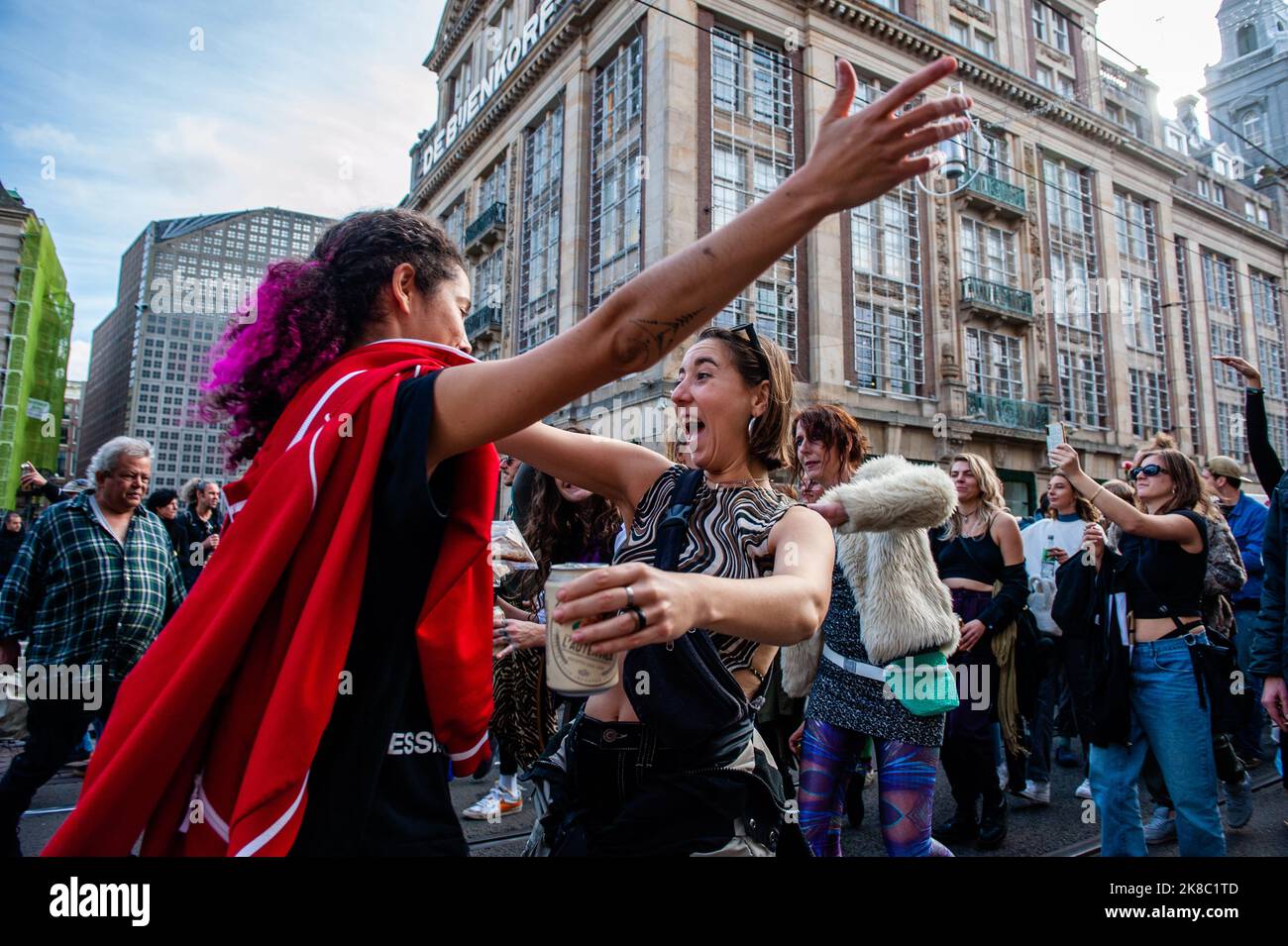 Two women are seen hugging each other while dancing during the ...