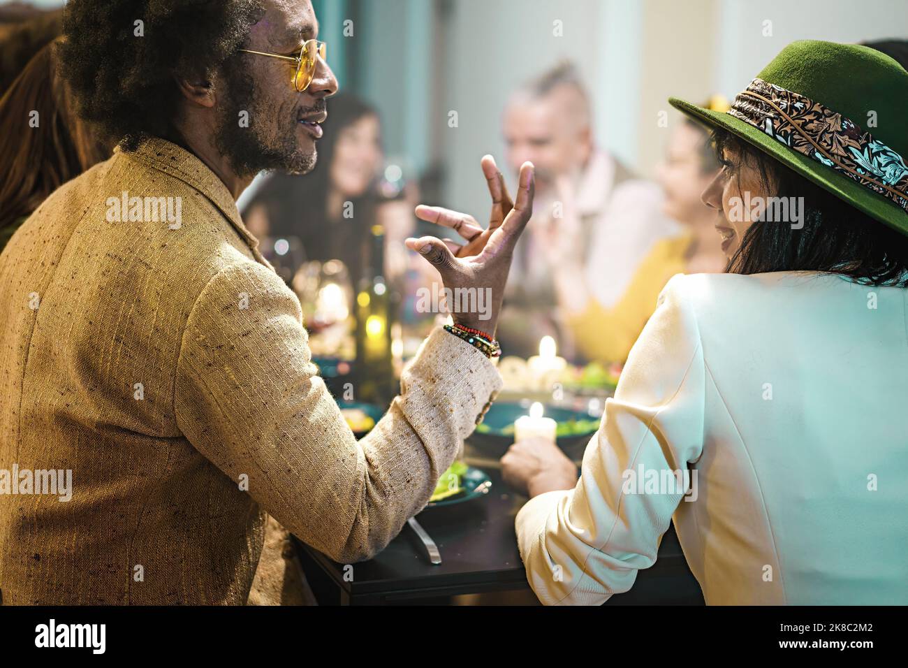 Multiethnic couple flirting at dining table in home Stock Photo - Alamy