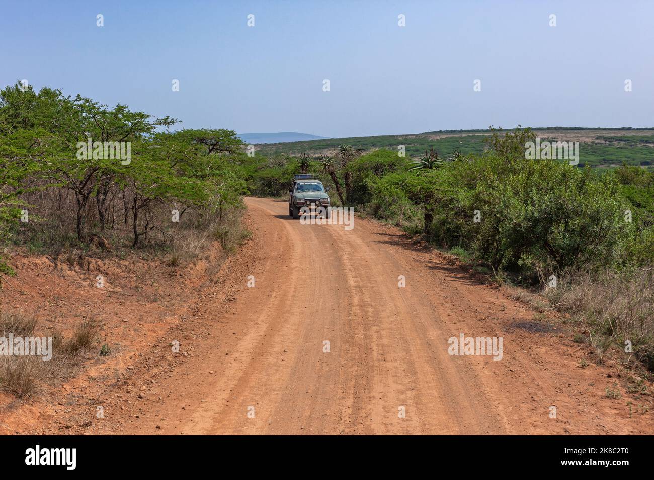 Wildlife Animal Park reserve dirt road with parksboard ranger vehicle ...