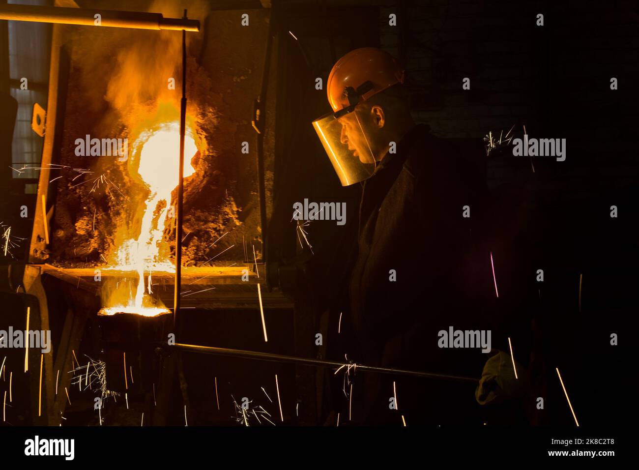 smelter worker pours liquid metal into a casting mold Stock Photo - Alamy