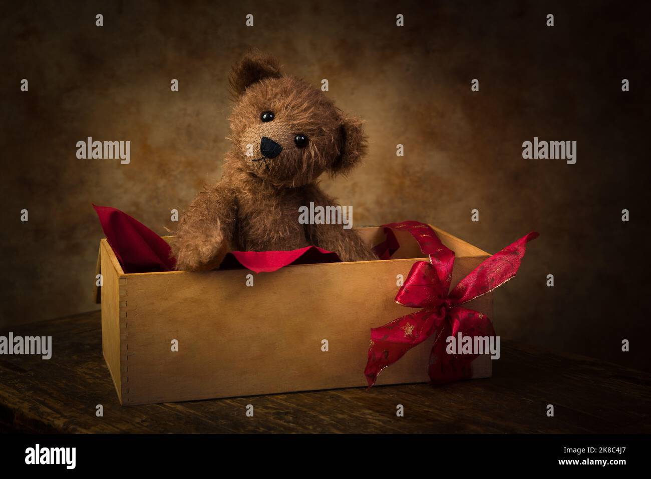 Cute little teddy bear tucked in a wooden box with a gift ribbon Stock ...