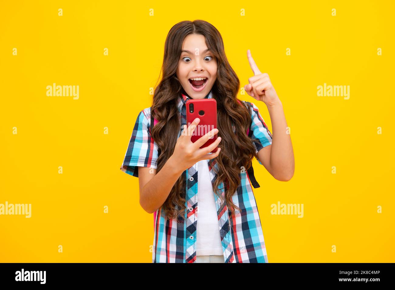 Mobile online shopping. Cute teen child girl paying with phone, texting ...