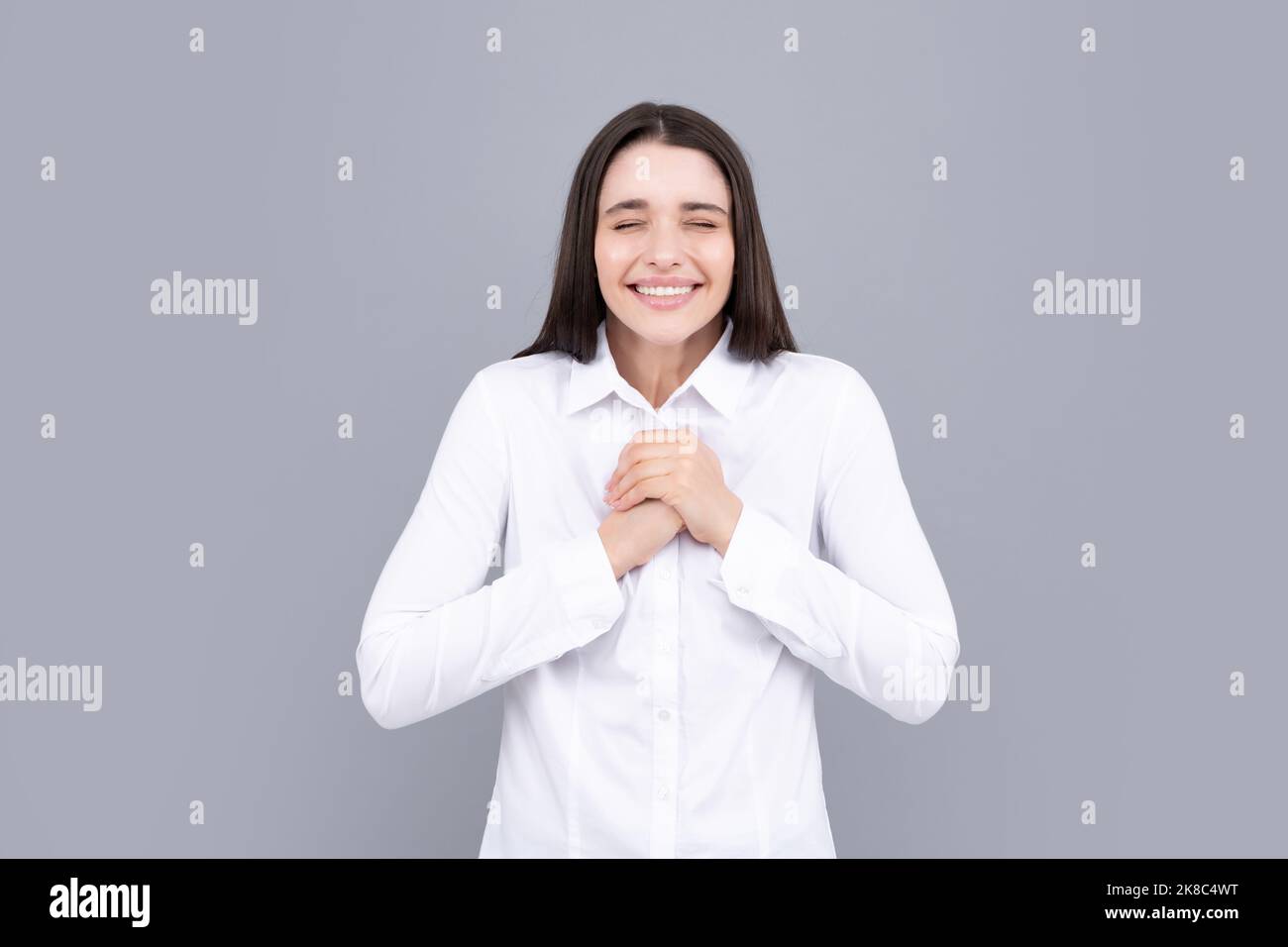 Pretty romantic young woman making a heart gesture, showing love and ...