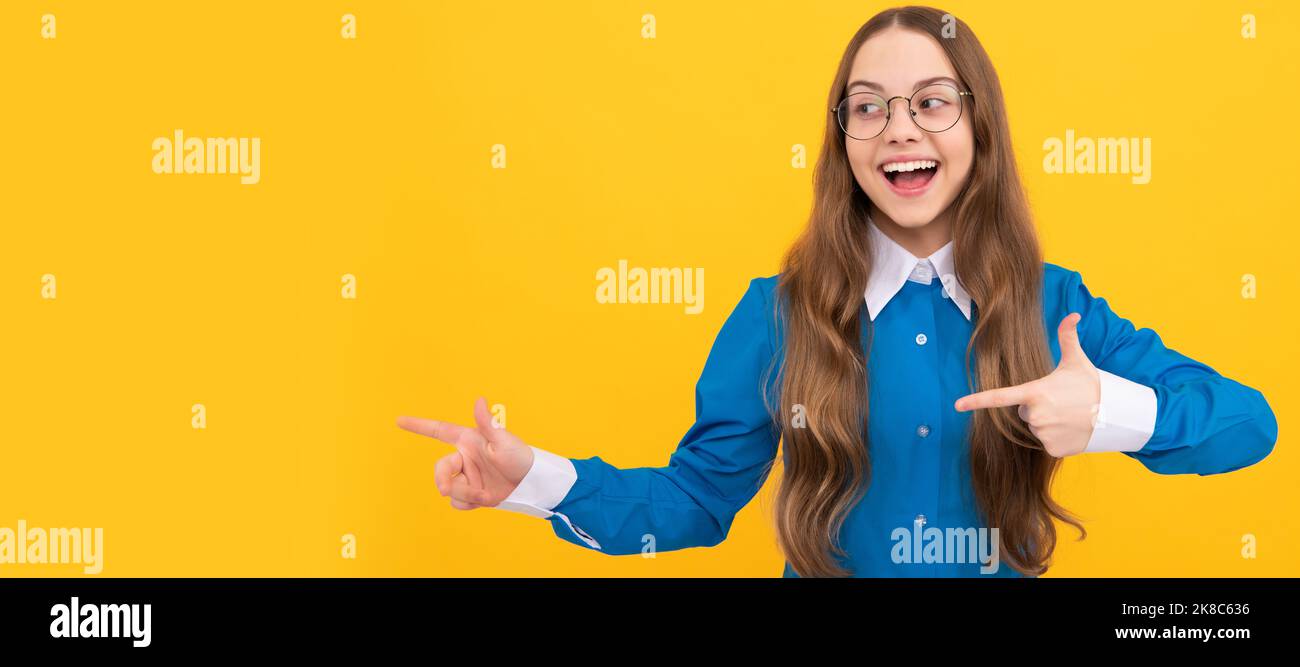 Happy back to school child point fingers for advertising yellow ...
