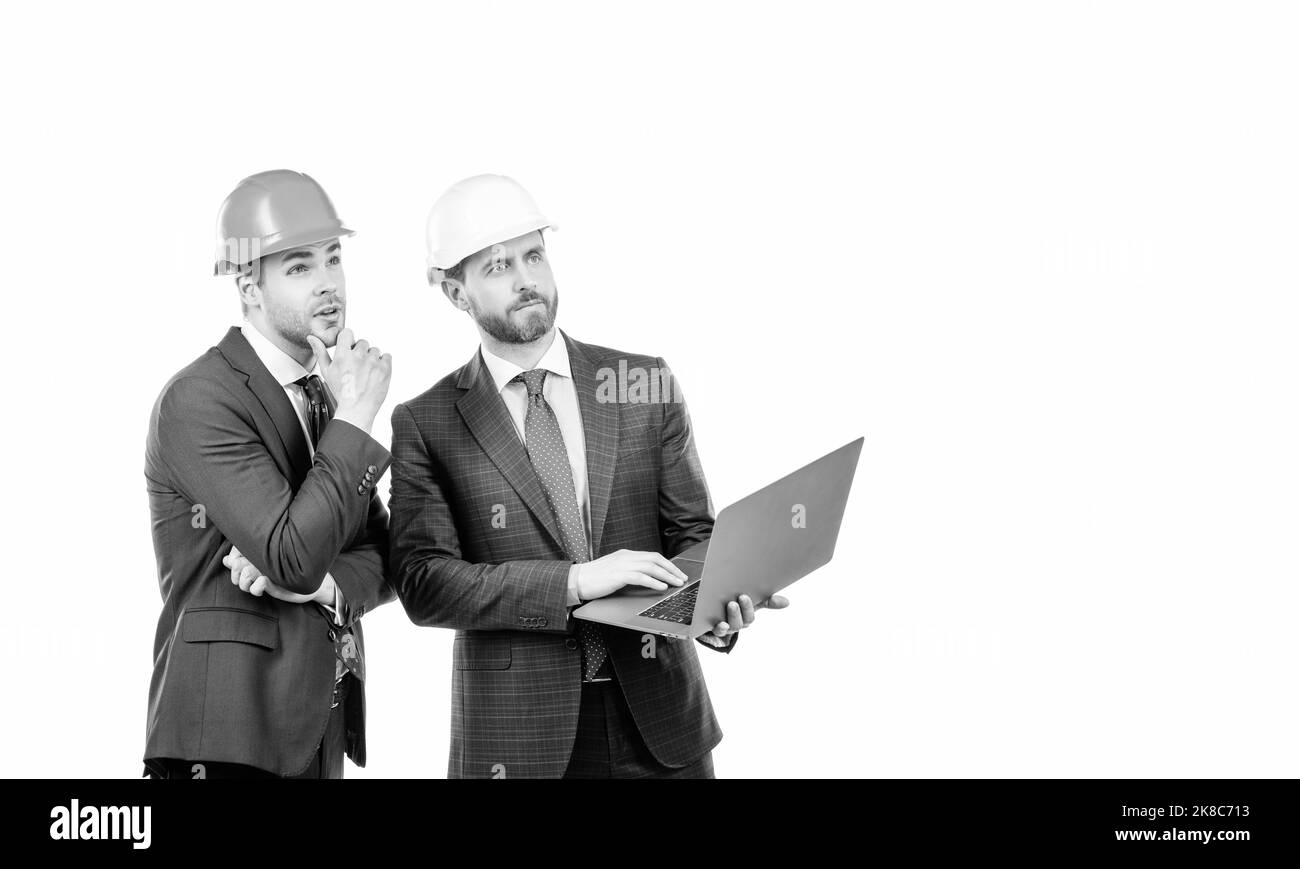 businessmen in helmet with laptop. architects planning work. chief ...