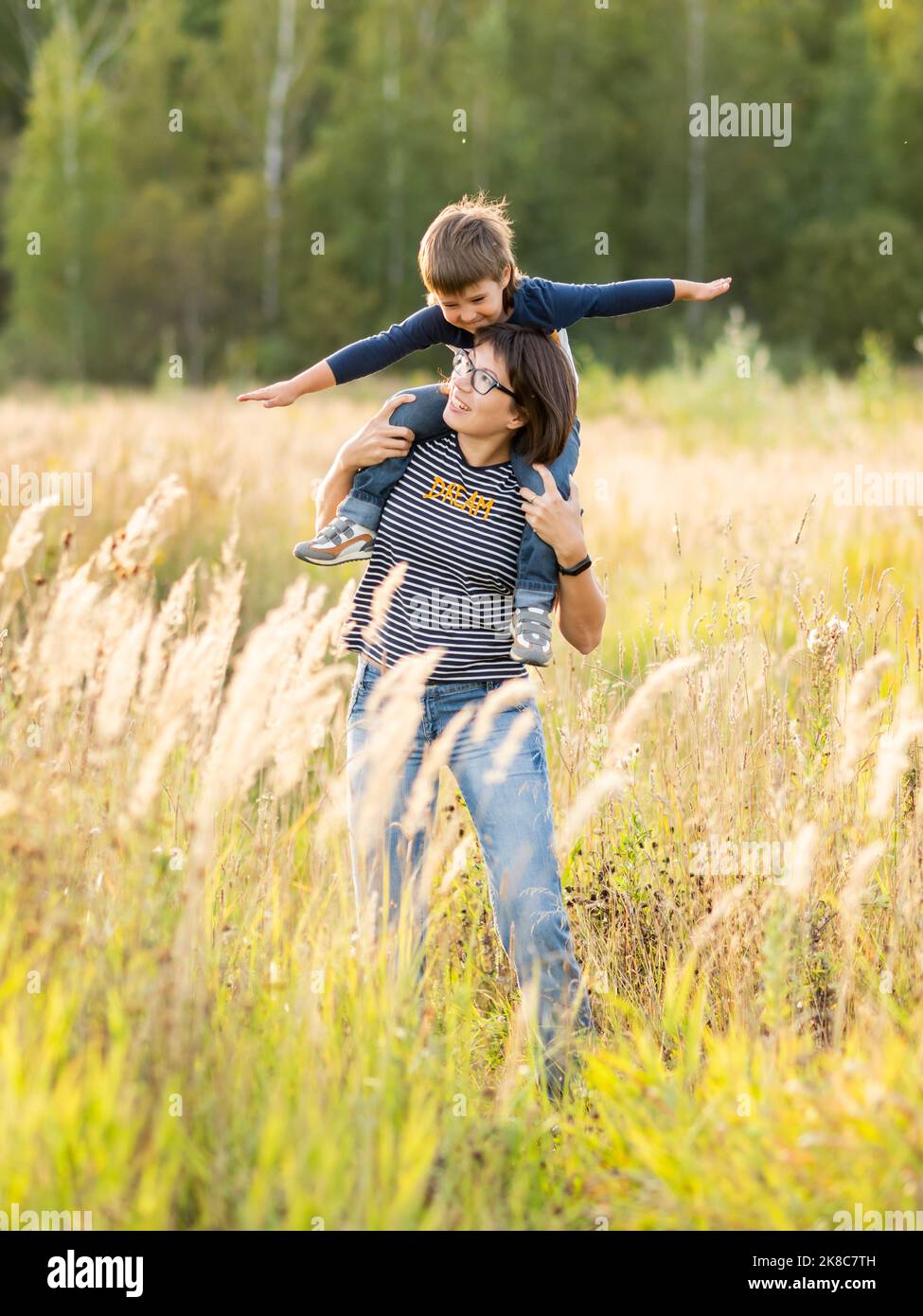 Cute boy and his mother play as airplane. Happy kid dreams to be a ...