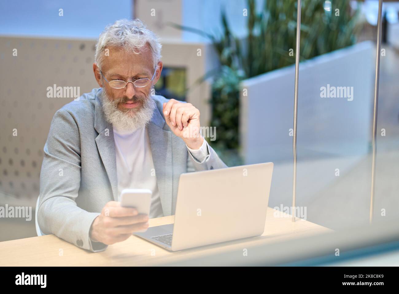 Older senior business man executive using mobile phone working in ...