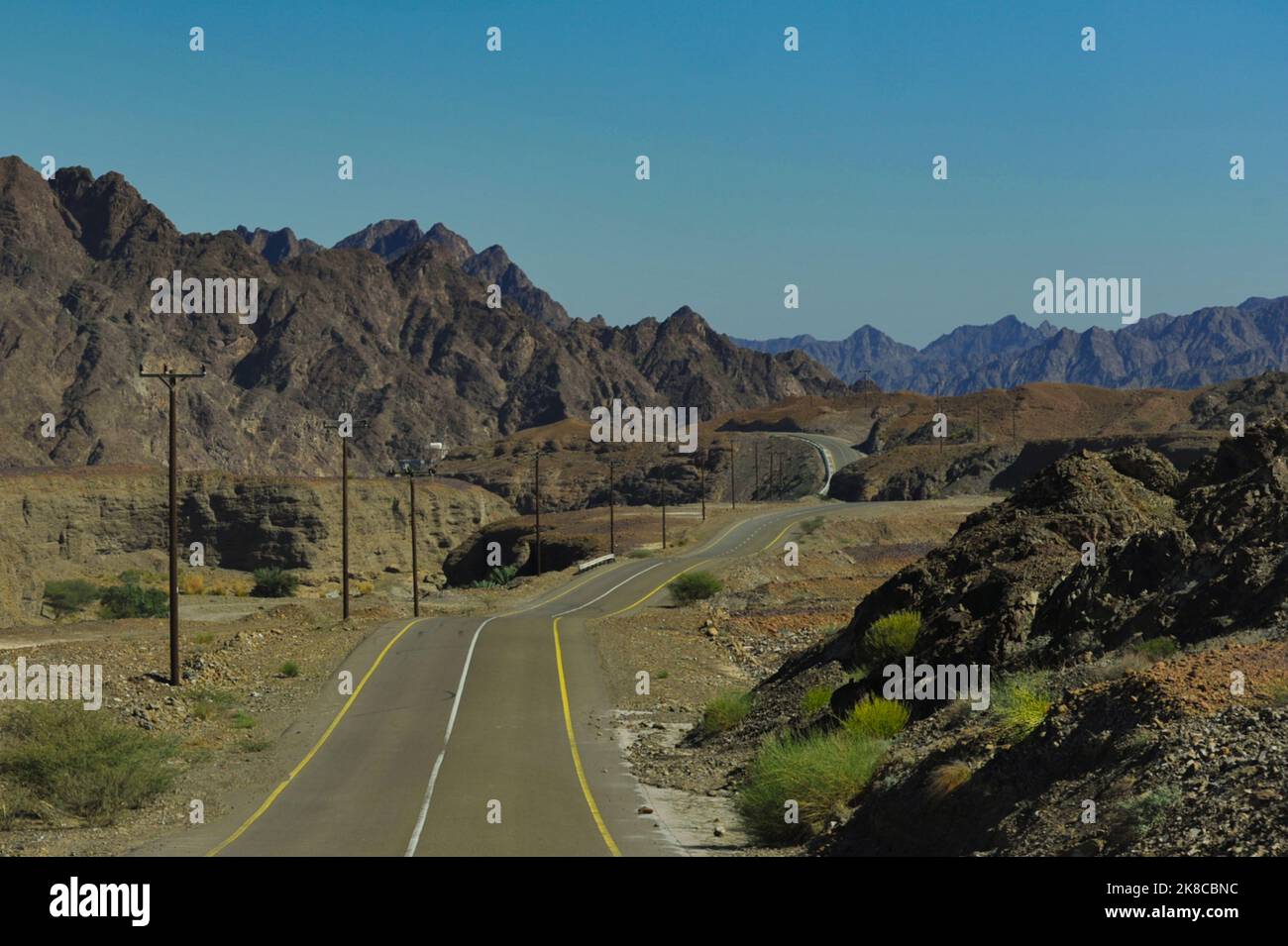 Scenic drive through a long, sloping road in Hatta, rocky Al-Hajar ...